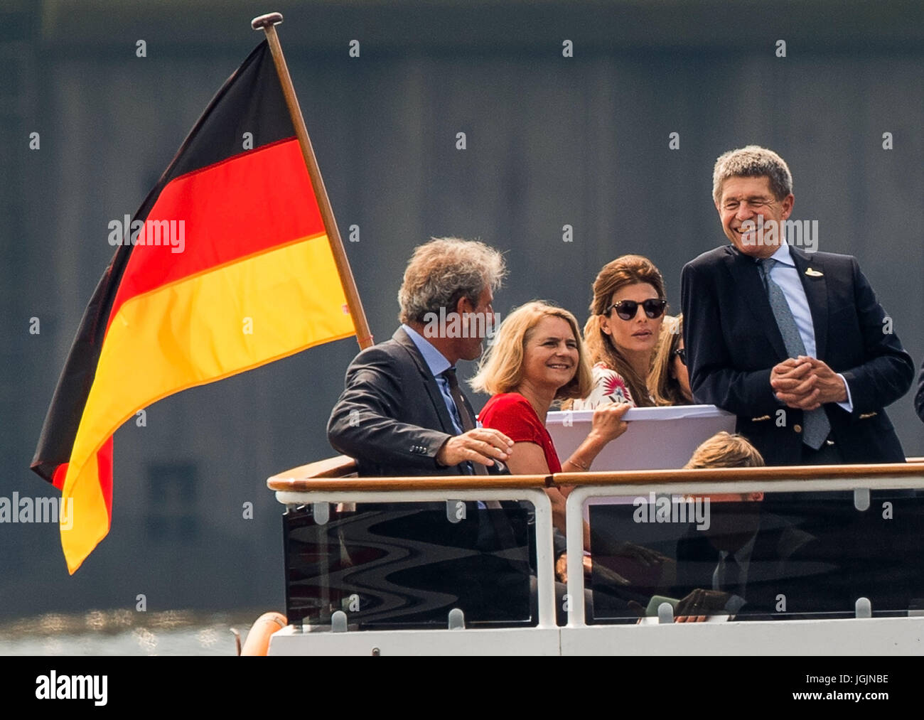 The husband of the German chancellor, Joachim Sauer (r), speaks to ...