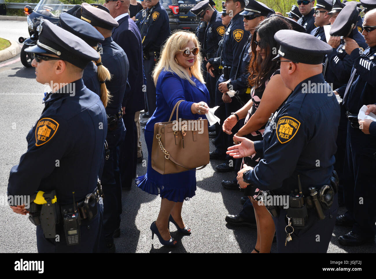 July 7, 2017 - San Antonio, Texas, USA - A woman passes out tissues to ...