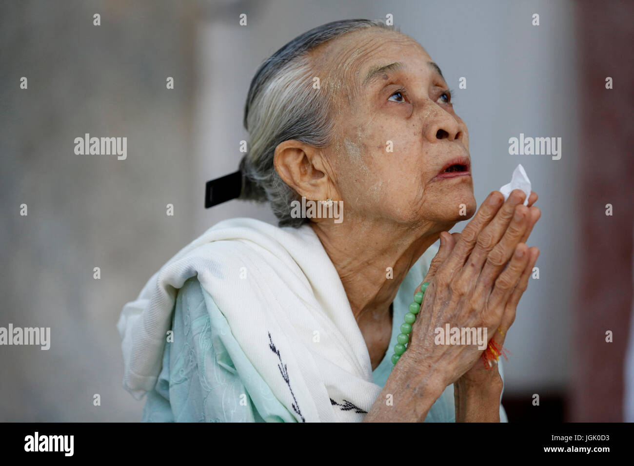 Yangon, Myanmar. 8th July, 2017. A Buddhist devotee pays homage during ...