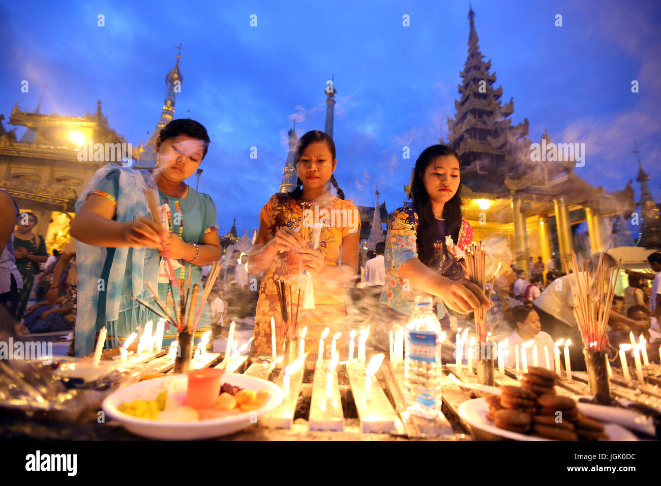 Yangon, Myanmar. 8th July, 2017. Buddhist devotees burn incense sticks ...