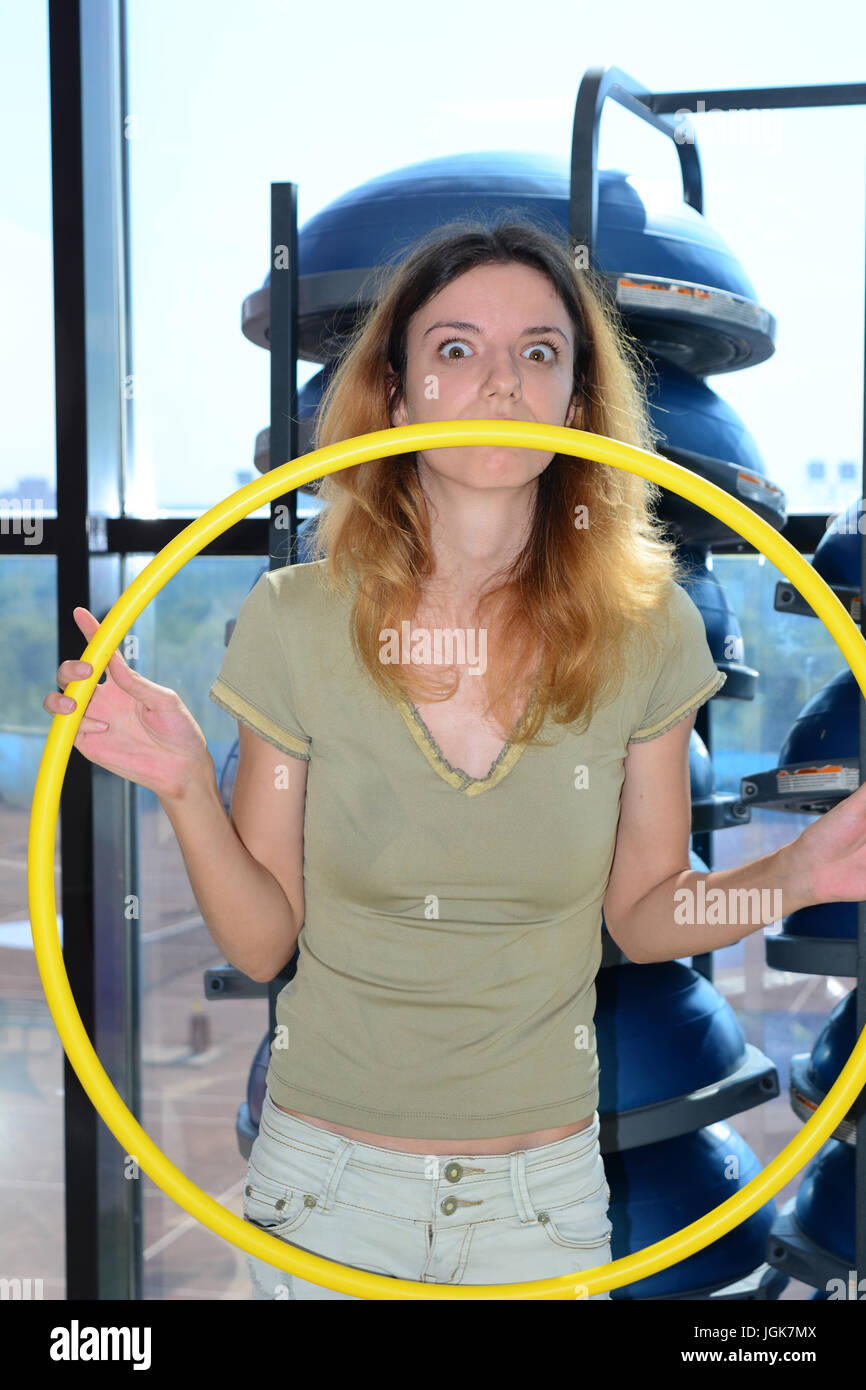 A female model playing with hula hoops at a gym Stock Photo - Alamy