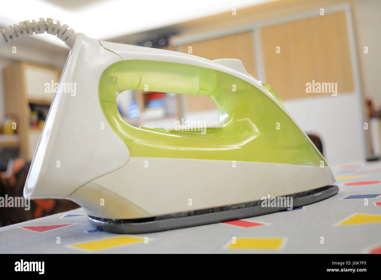 a sad iron isolated on a ironing table Stock Photo - Alamy