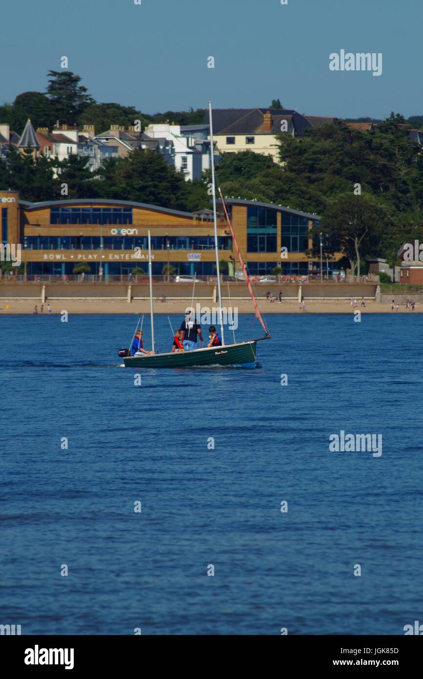 Summer Boating Fun. Young Family on a Green Sail Boat. Exmouth from ...