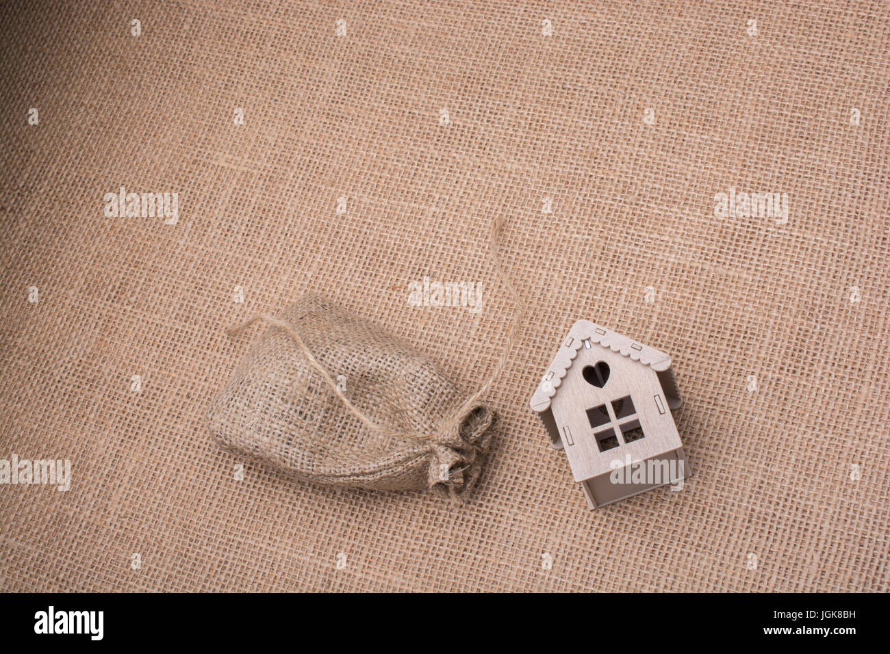 Model house beside a sack on a canvas background Stock Photo - Alamy
