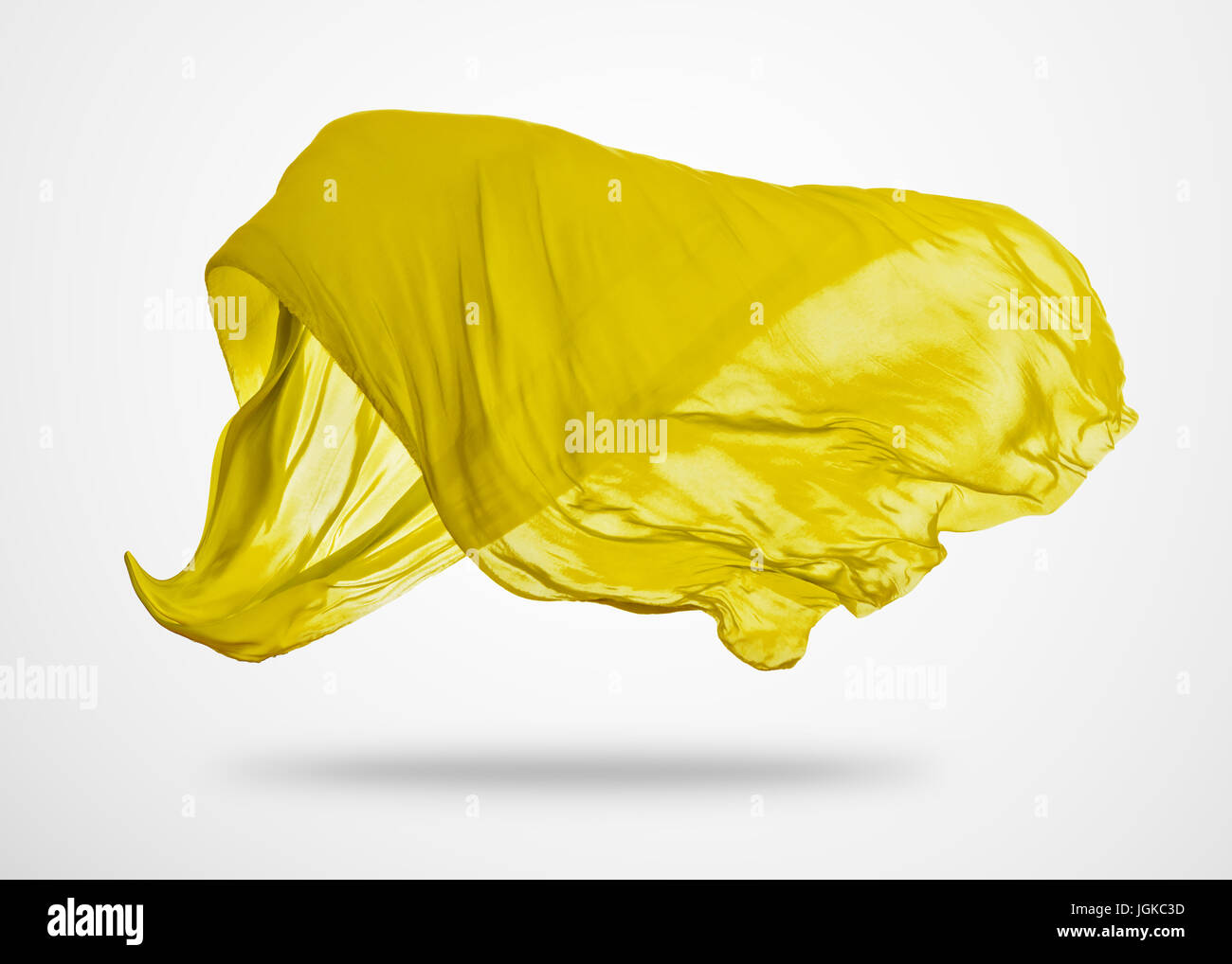 Smooth elegant yellow transparent cloth separated on gray background ...