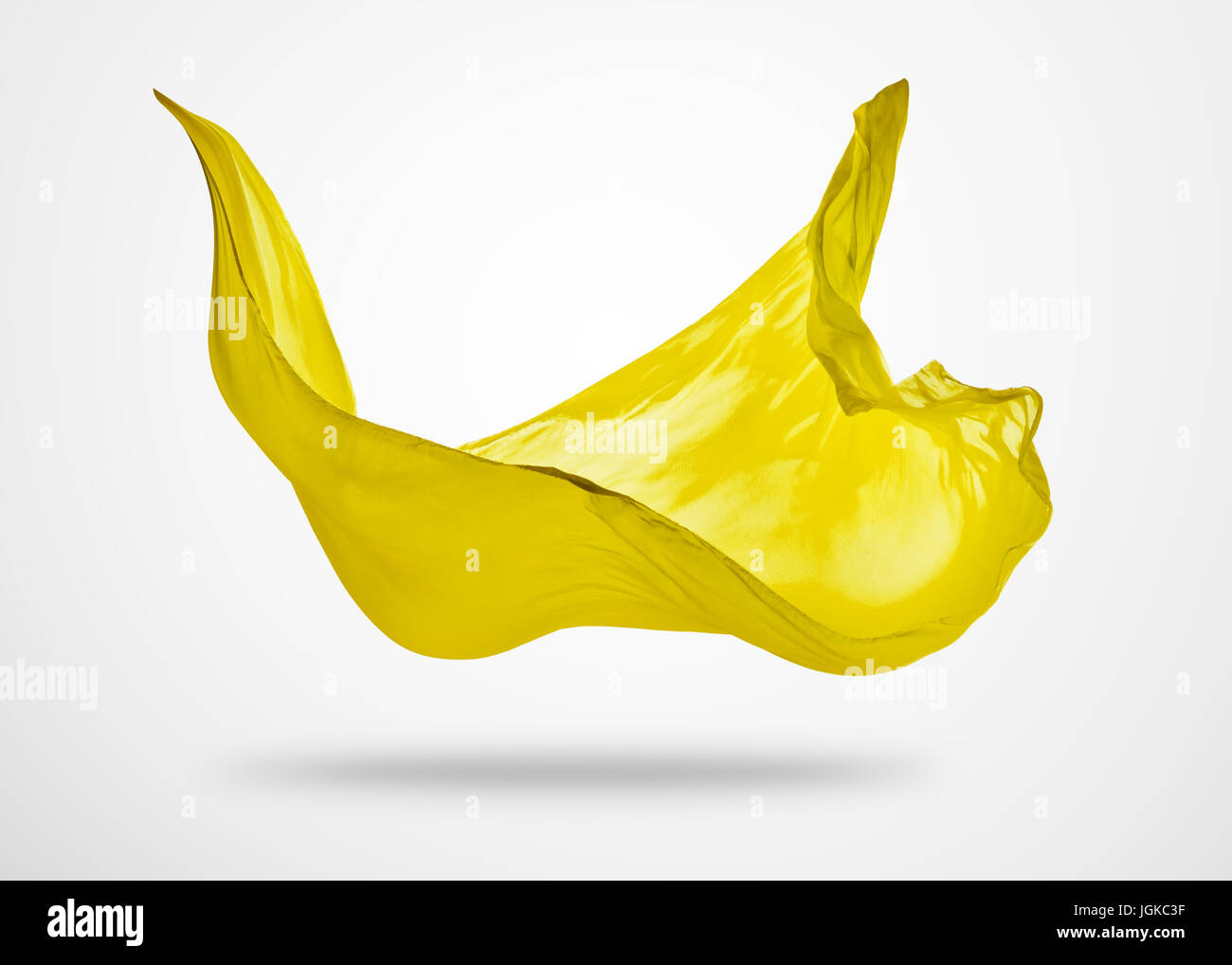 Smooth elegant yellow transparent cloth separated on gray background ...