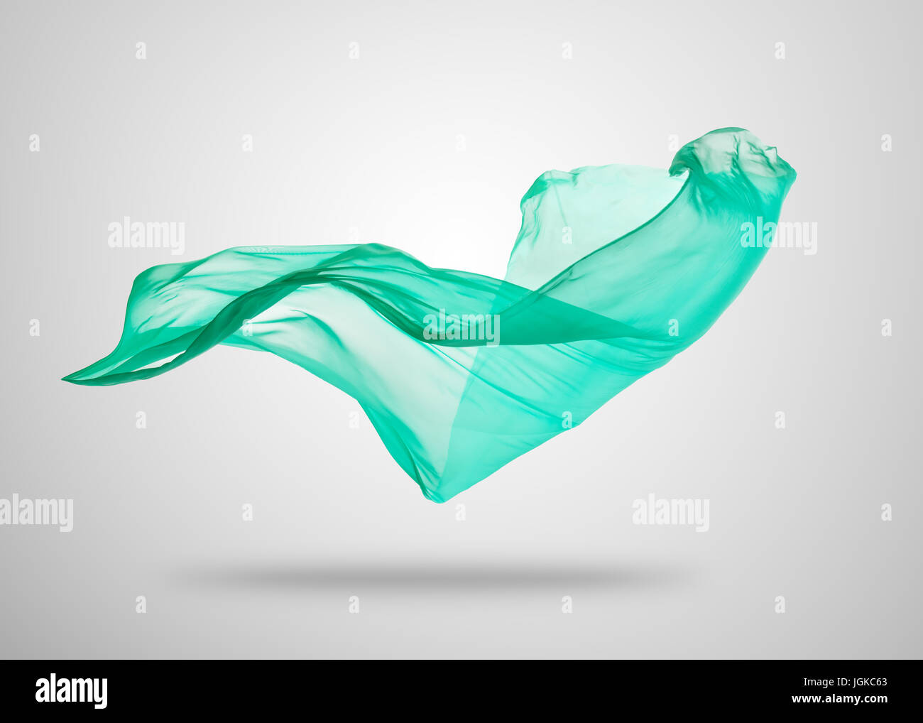 Smooth elegant transparent green cloth separated on gray background ...
