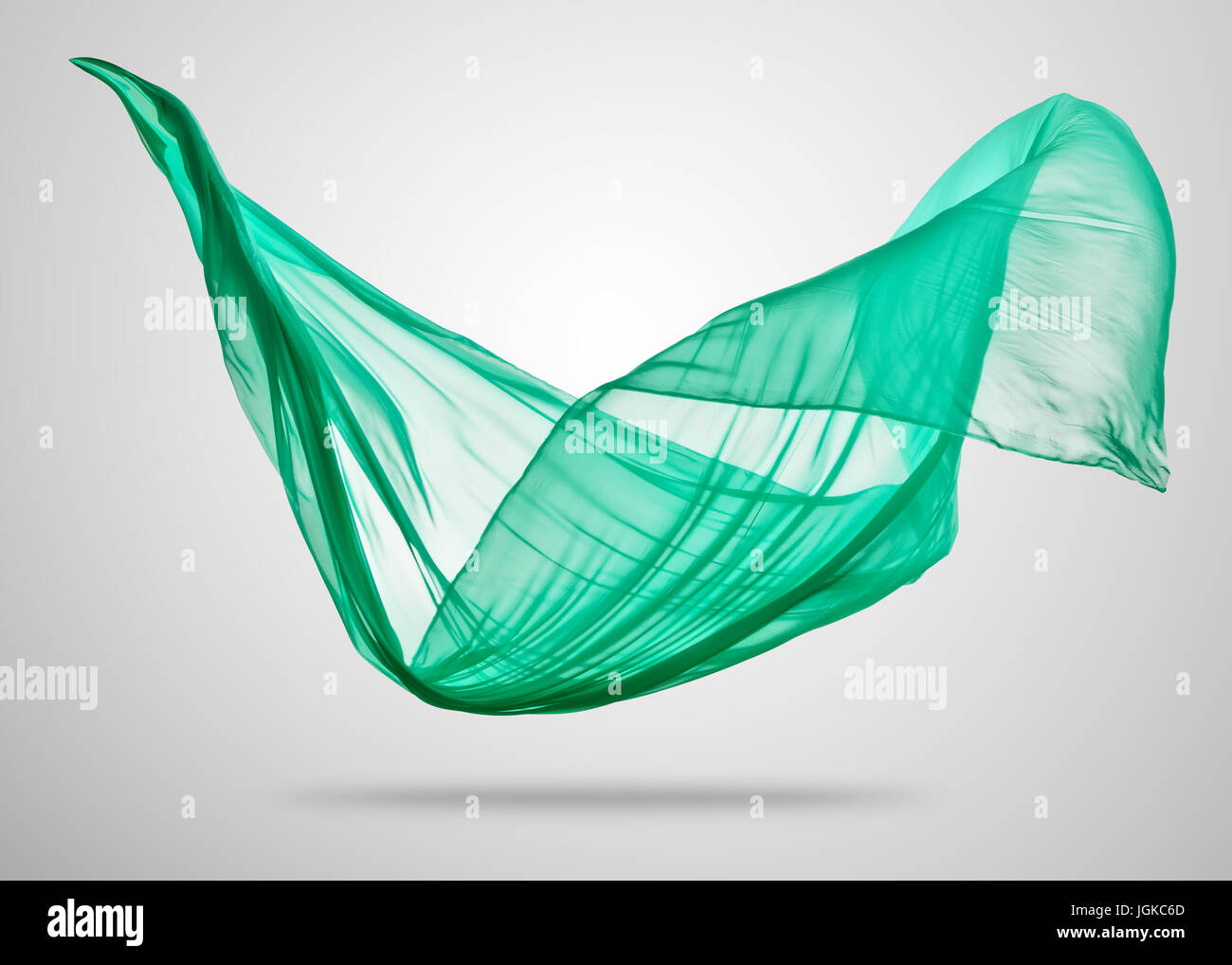 Smooth elegant transparent green cloth separated on gray background ...