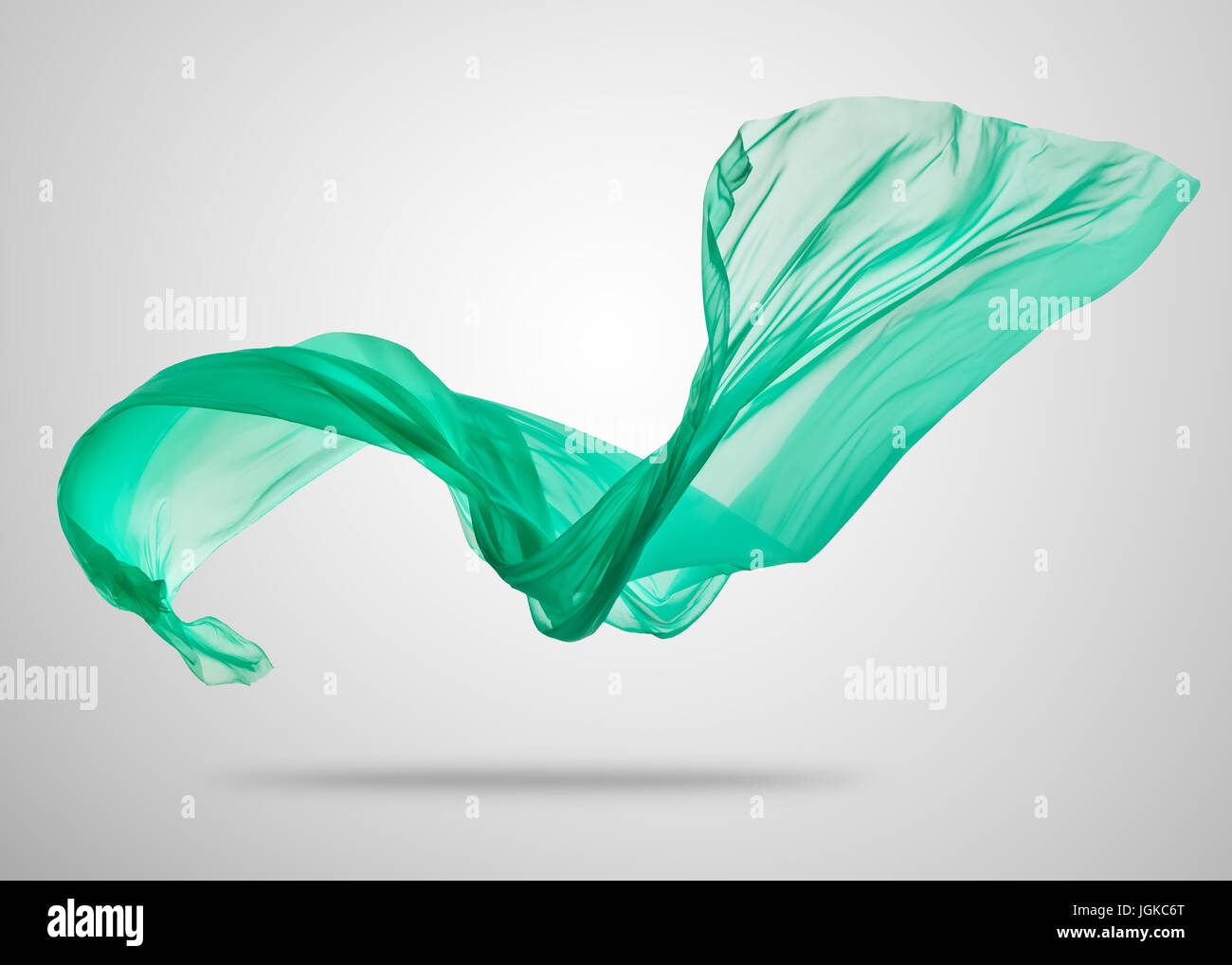 Smooth elegant transparent green cloth separated on gray background ...