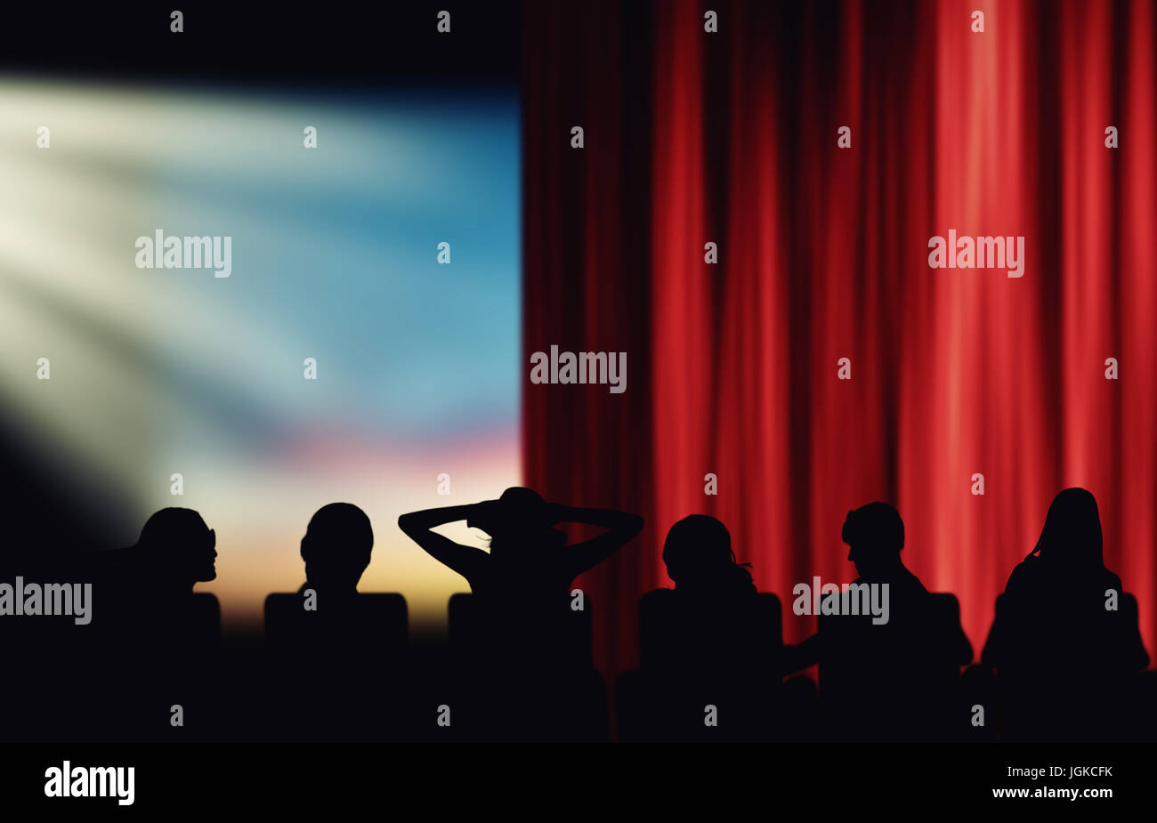 Silhouettes of cinema spectators watching movie. Red curtain on ...