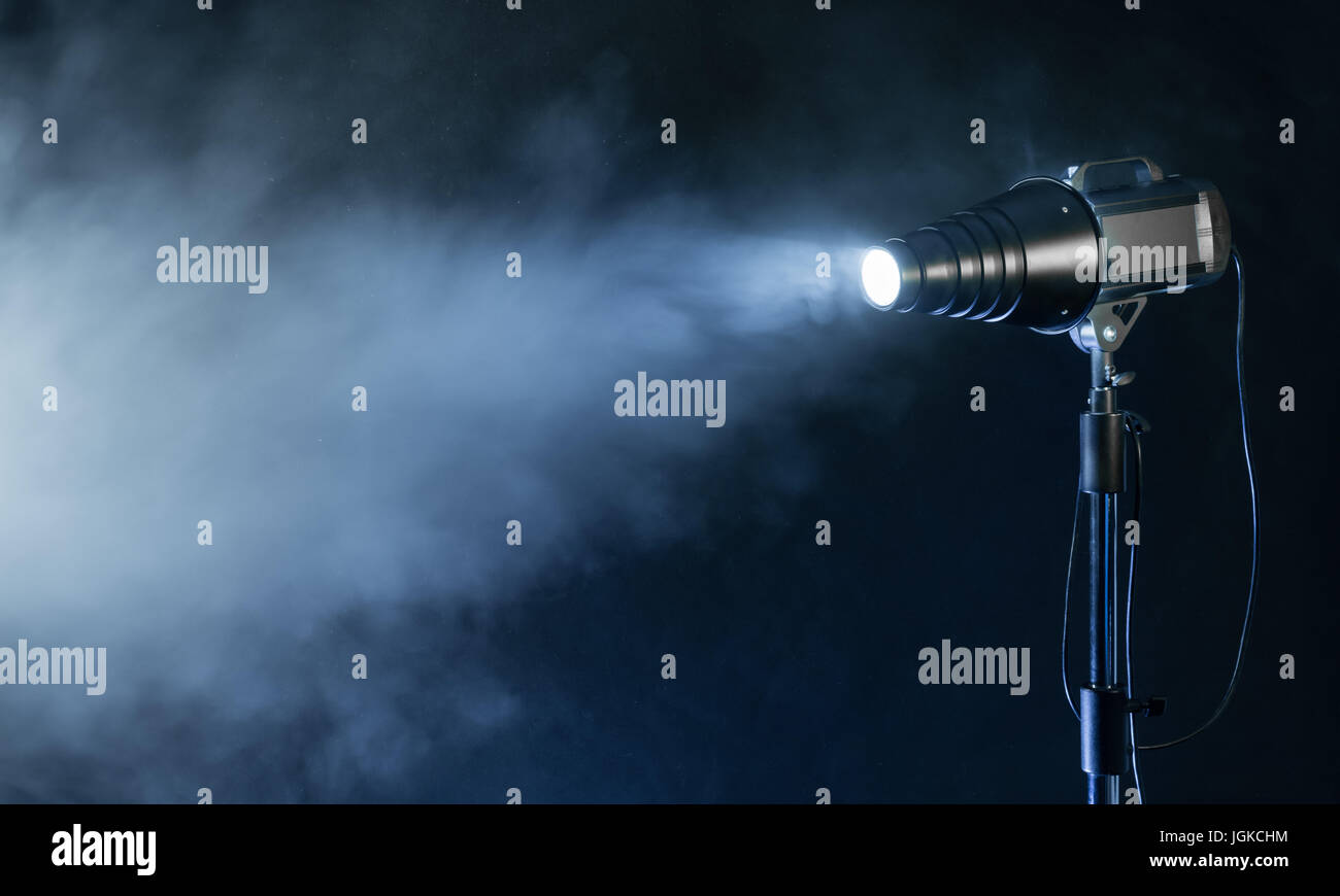 Studio spot light with smoke effect on black background Stock Photo - Alamy