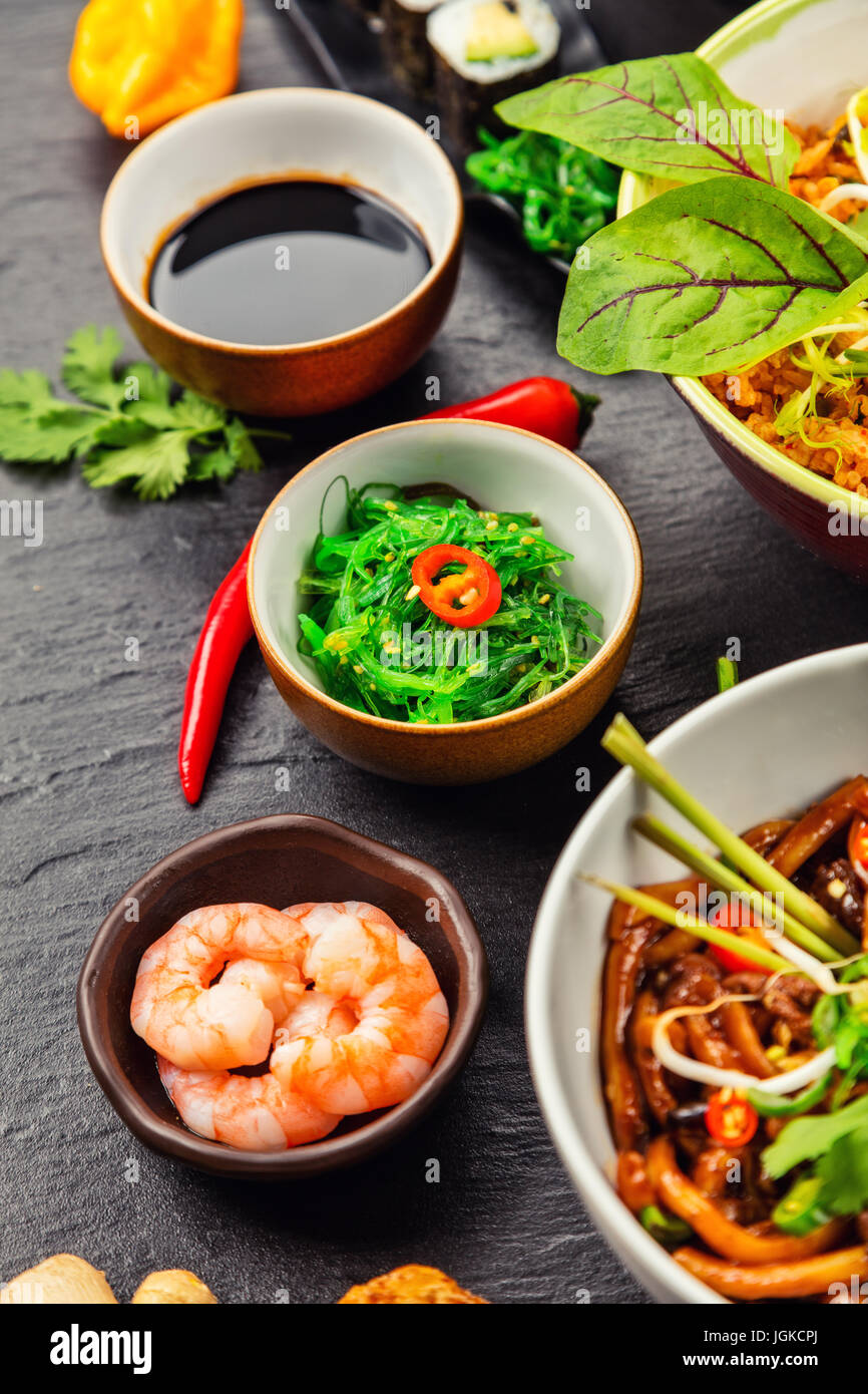 Asian food served on black stone. Chinese and vietnamese cuisine set ...