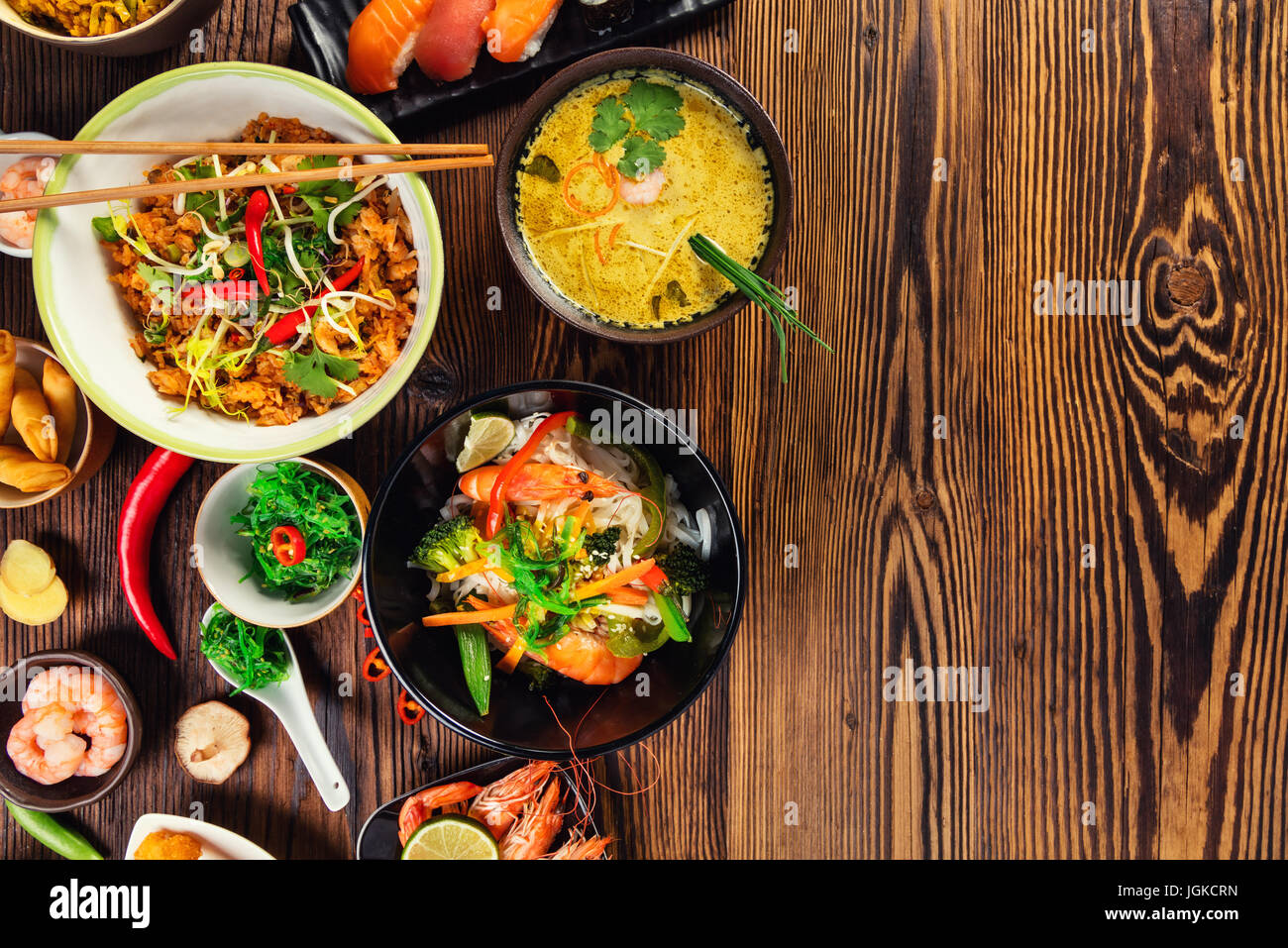 Asian food served on old wooden table, top view, space for text ...