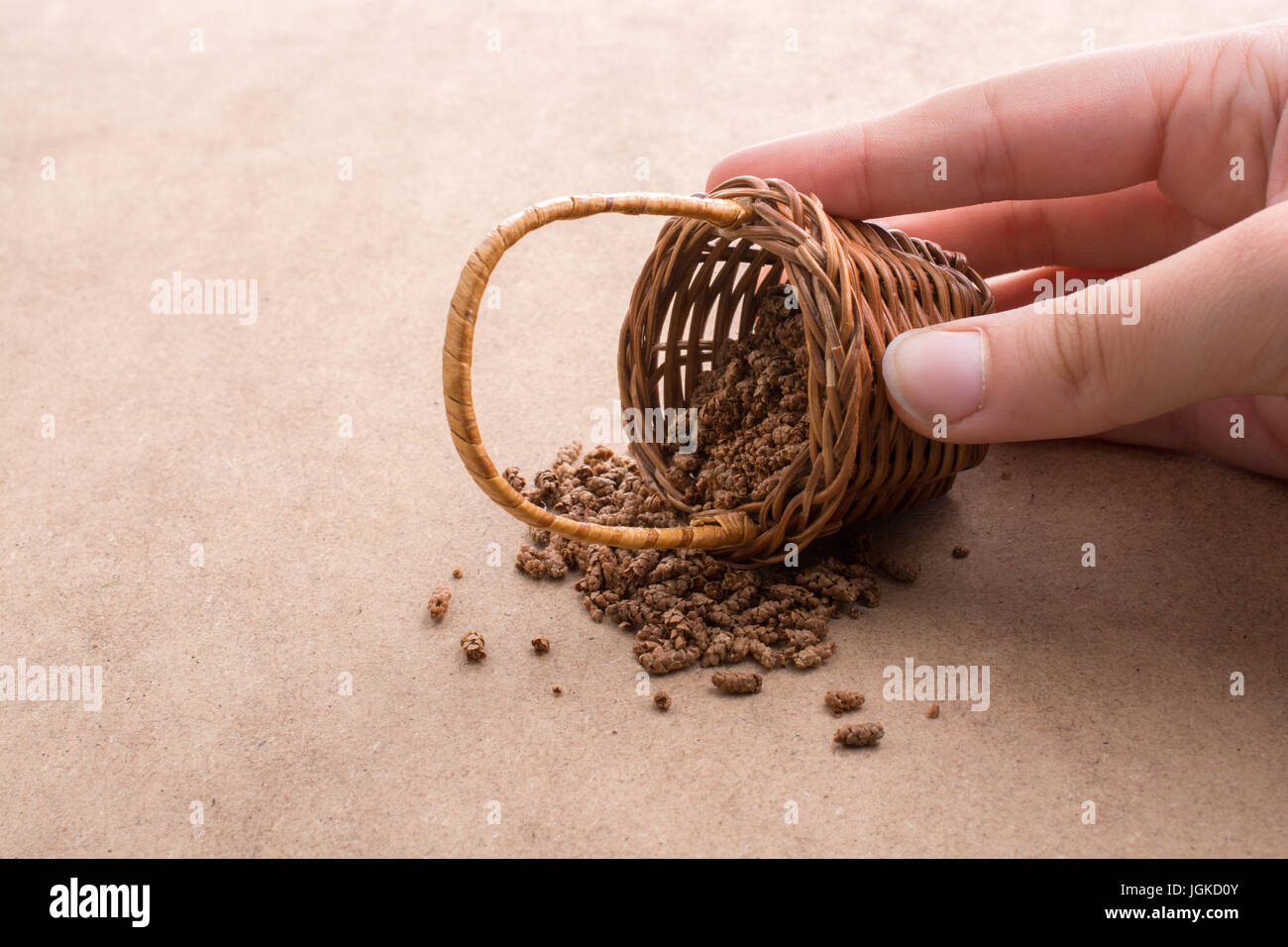 Hand holding a wicker basket on a canvas background Stock Photo - Alamy