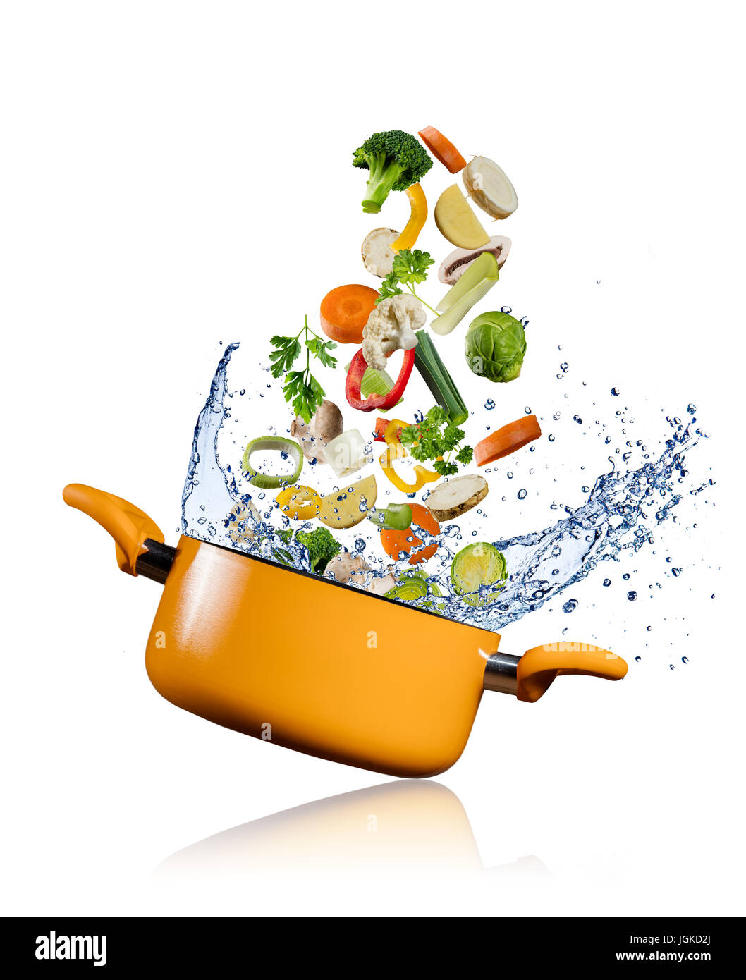 Fresh vegetables flying into a pot with water splash, isolated on white ...