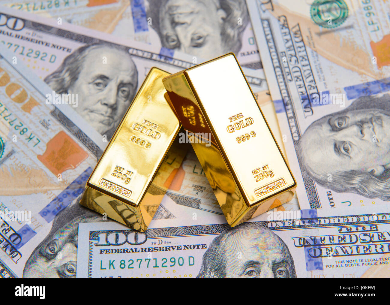 Two gold bar with new american hundred dollar bills Stock Photo - Alamy