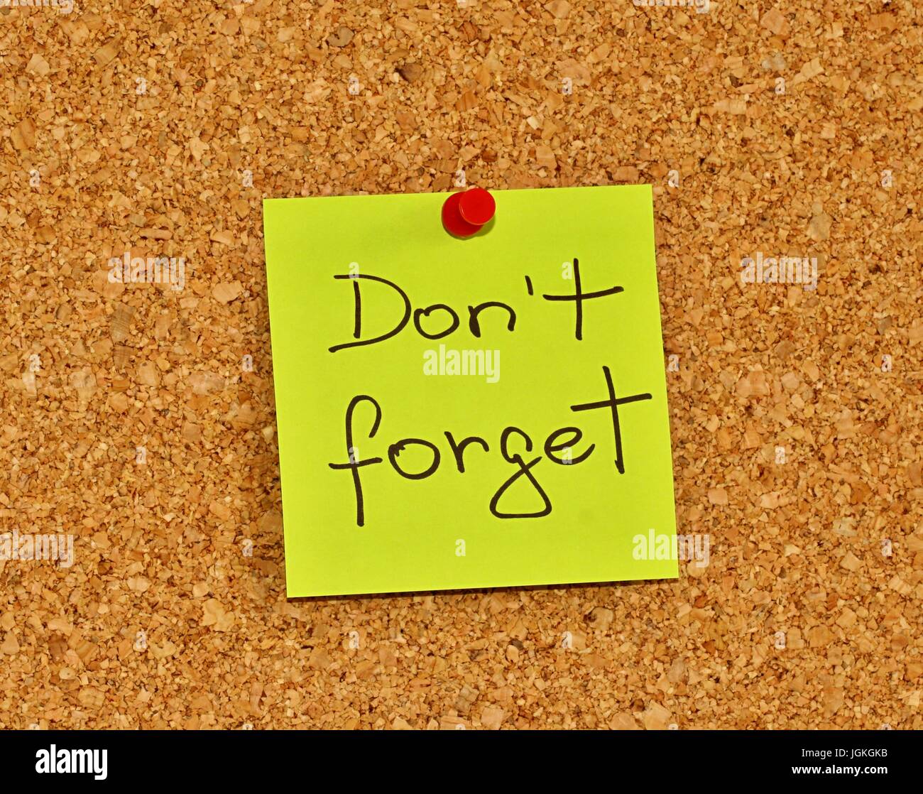 Cork notice board with one yellow sticky note pad with text please do ...