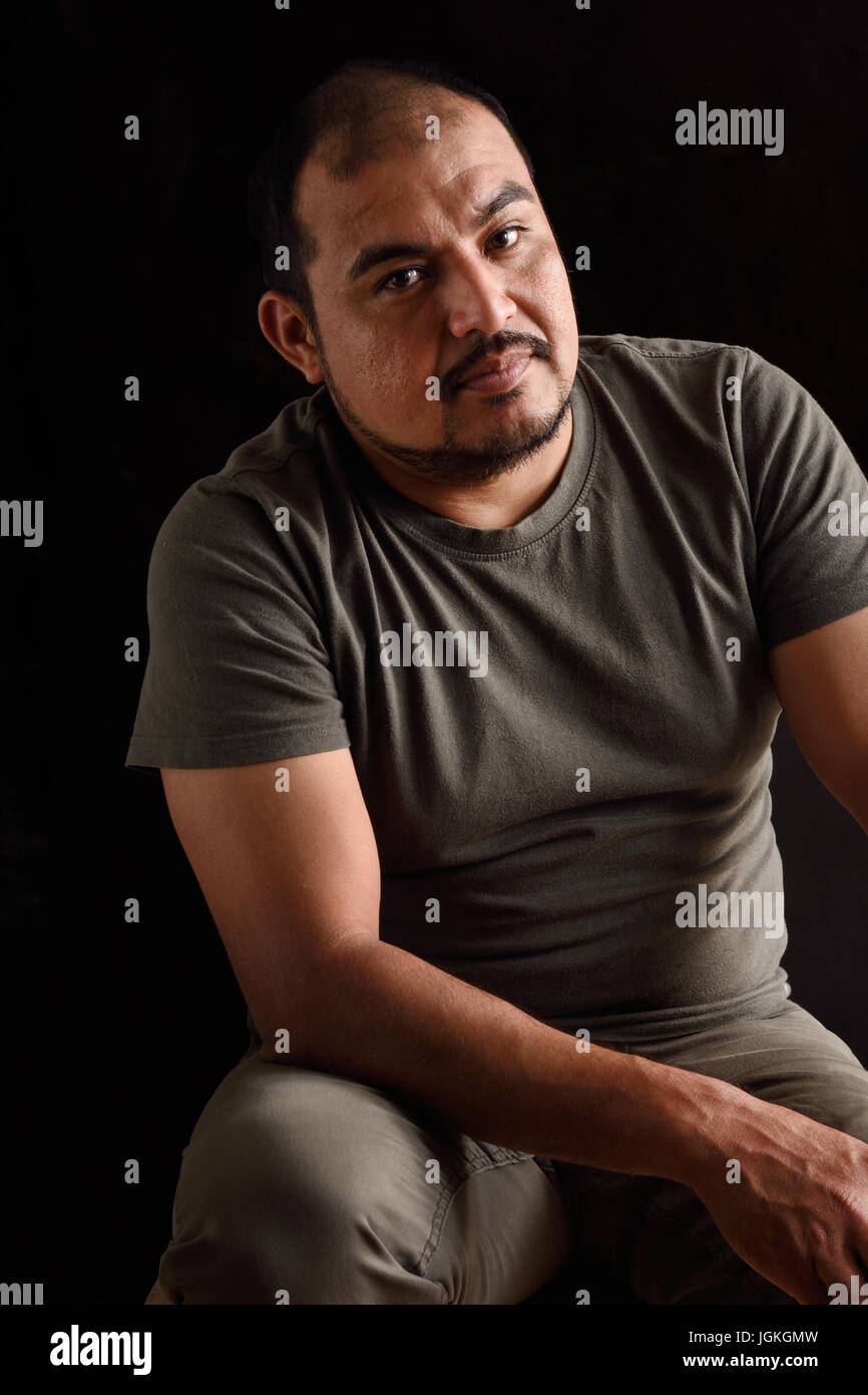 Portrait of a latin man on black background Stock Photo - Alamy