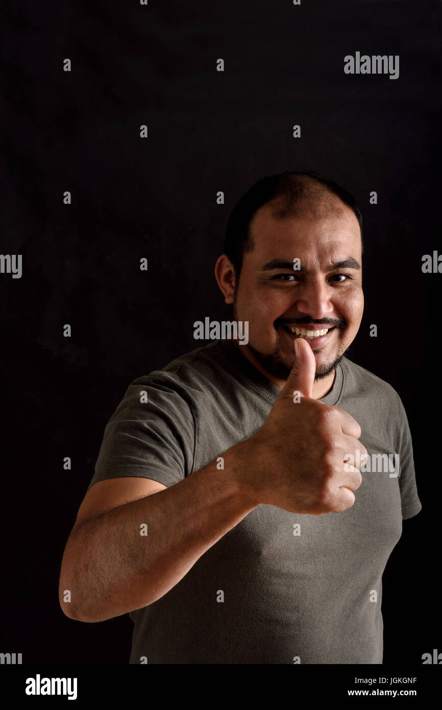 man doing the sign thumbs up on white background Stock Photo - Alamy