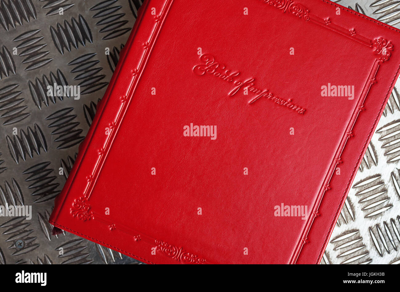 Closeup view of red leather book of impressions Stock Photo - Alamy