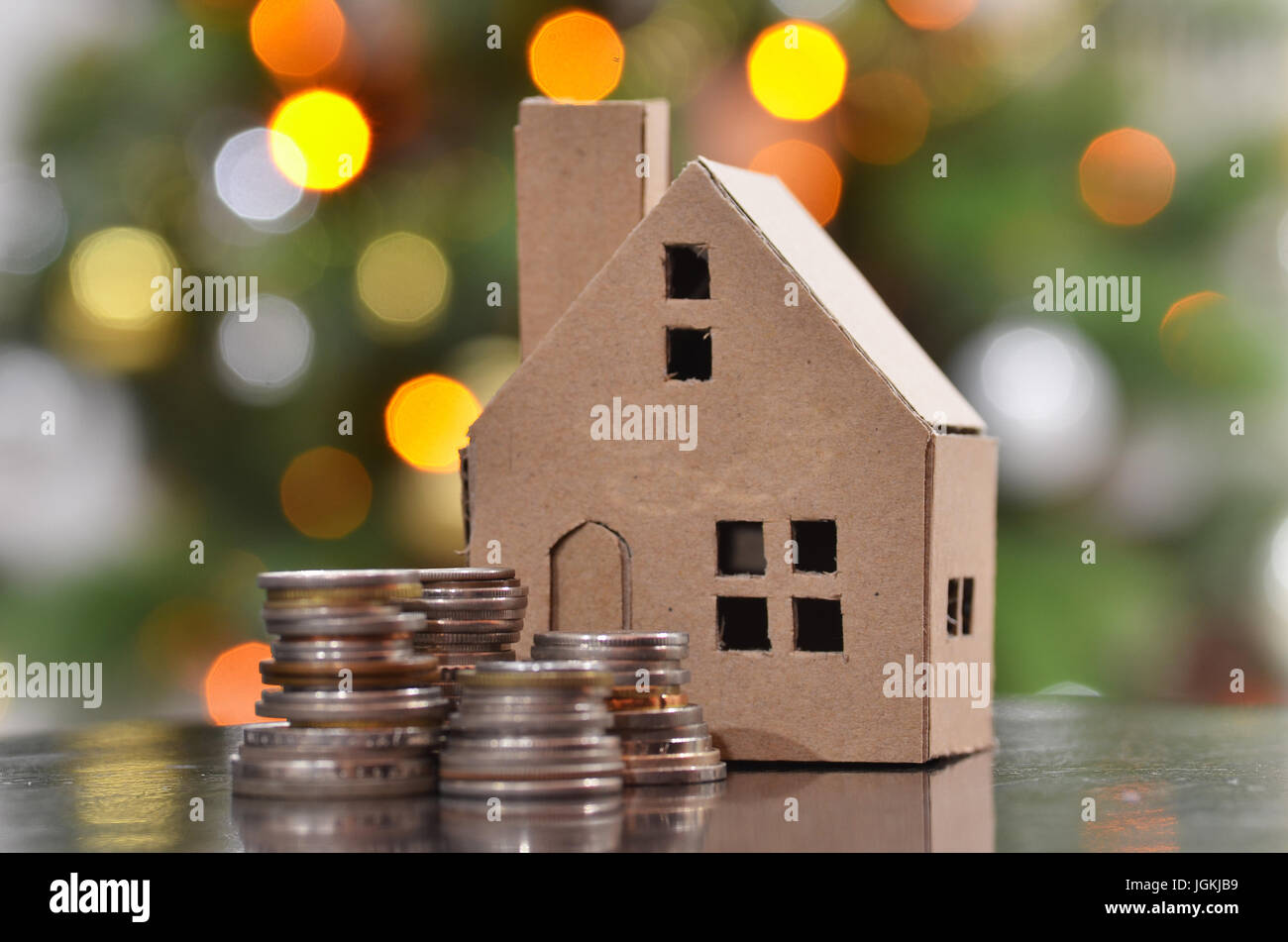 Model of house with coins on wooden table on blurred background Stock ...