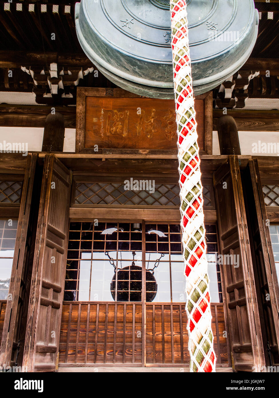 Bell rope, and bell, at the door to the temple, with temple nameboard ...