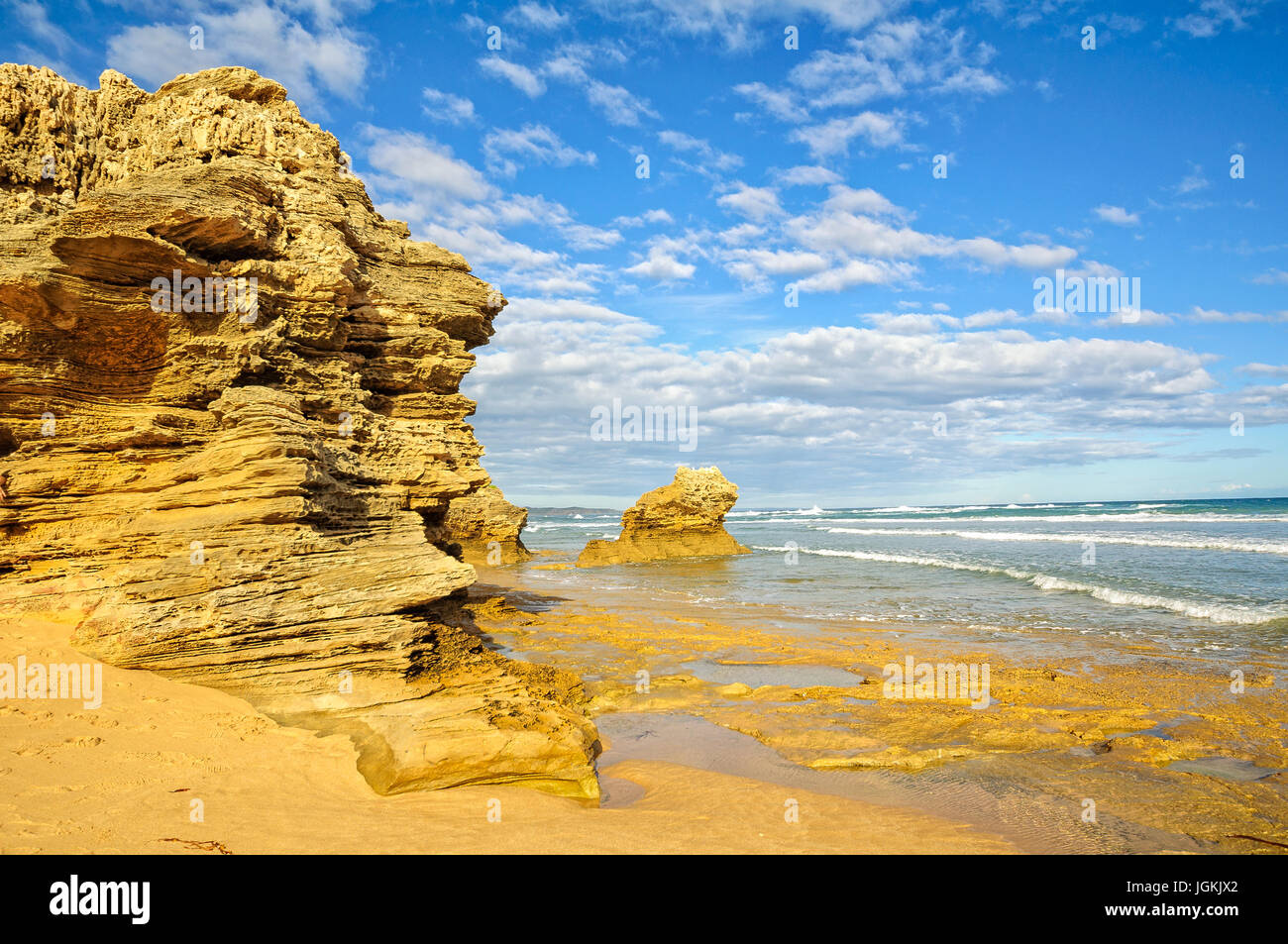Sculptured rocks under blue sky and light clouds at Point Lonsdale ...