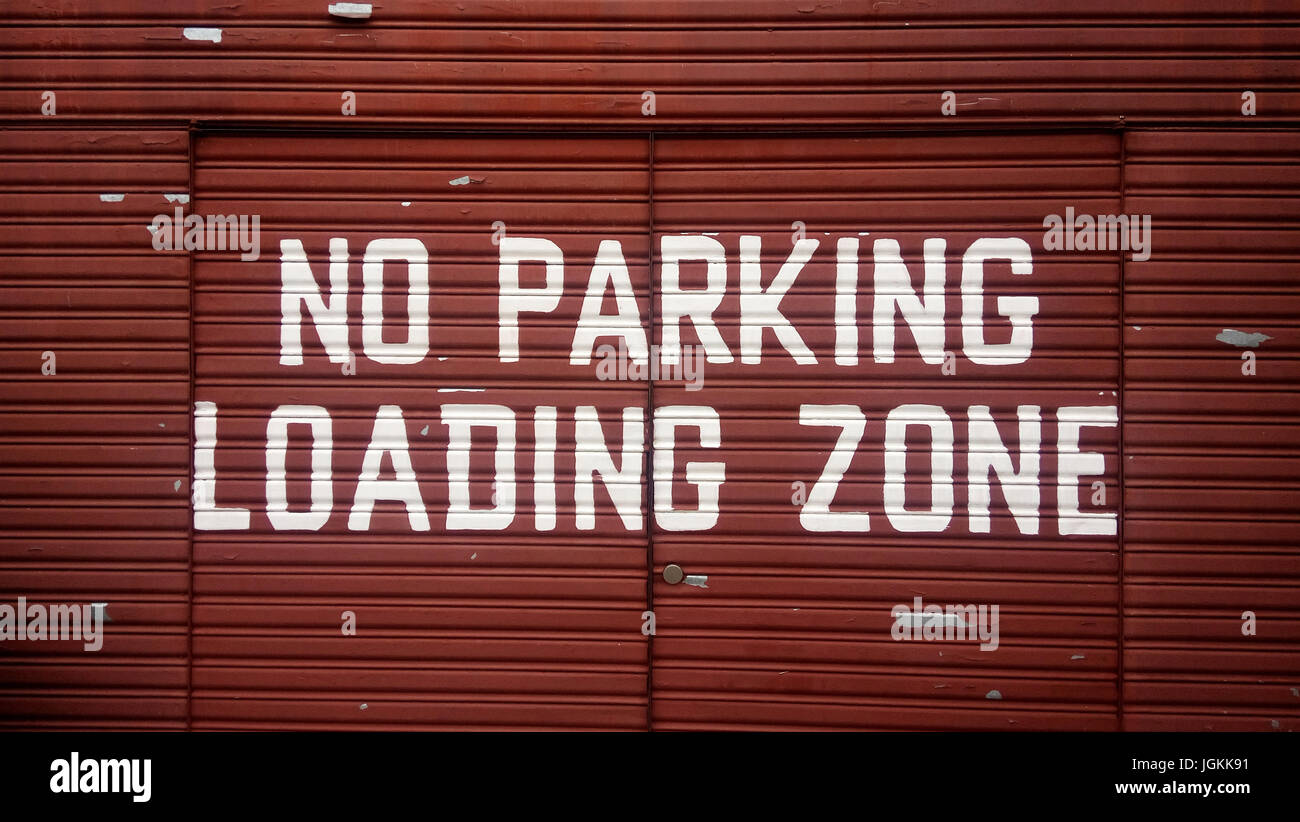No parking loading zone sign on red metal door Stock Photo - Alamy