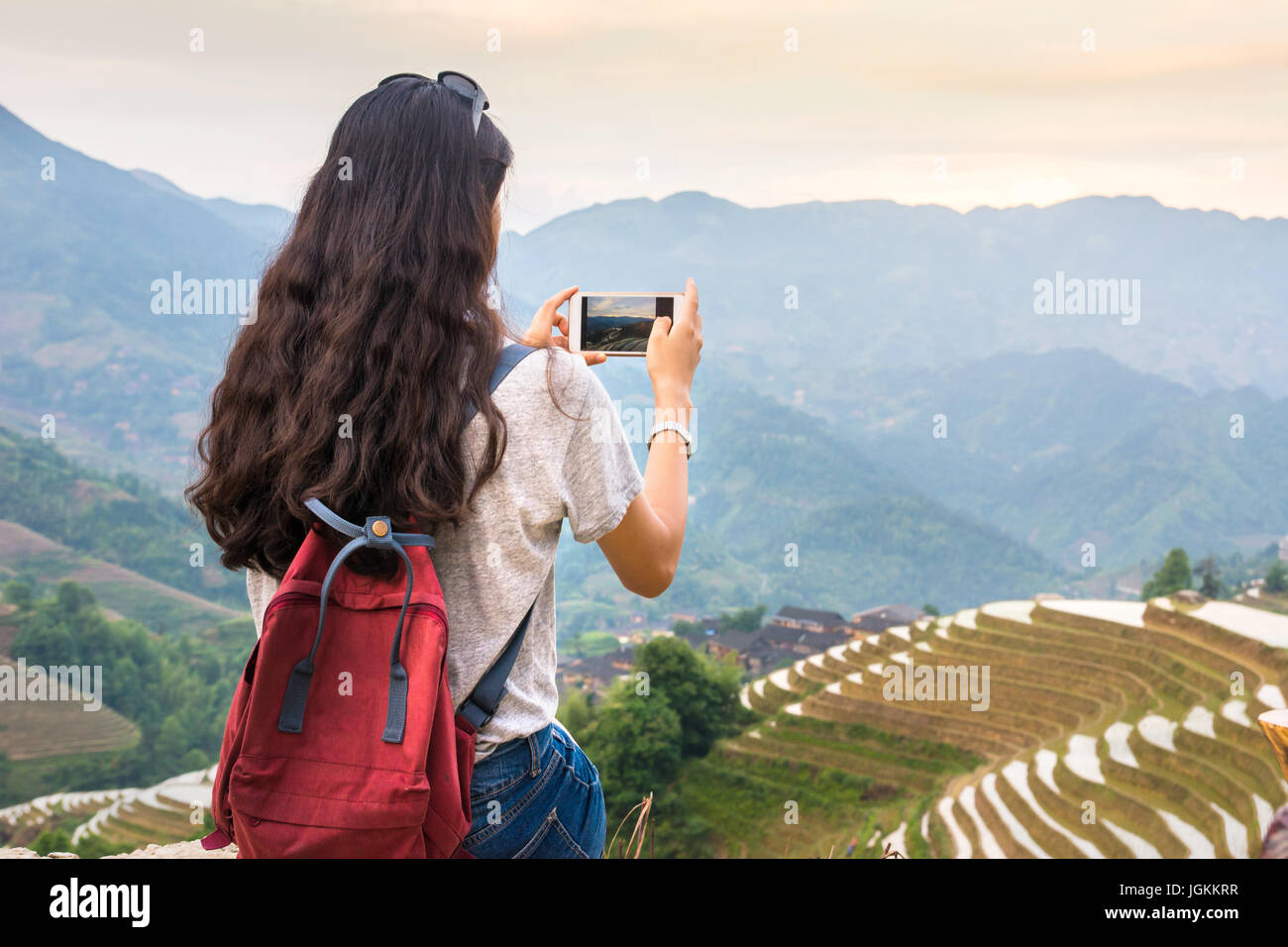 Girl enjoying sunset at terraced rice field in Longji, Guilin area ...