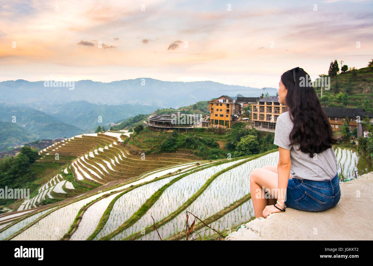 Girl enjoying sunset at terraced rice field in Longji, Guilin area ...