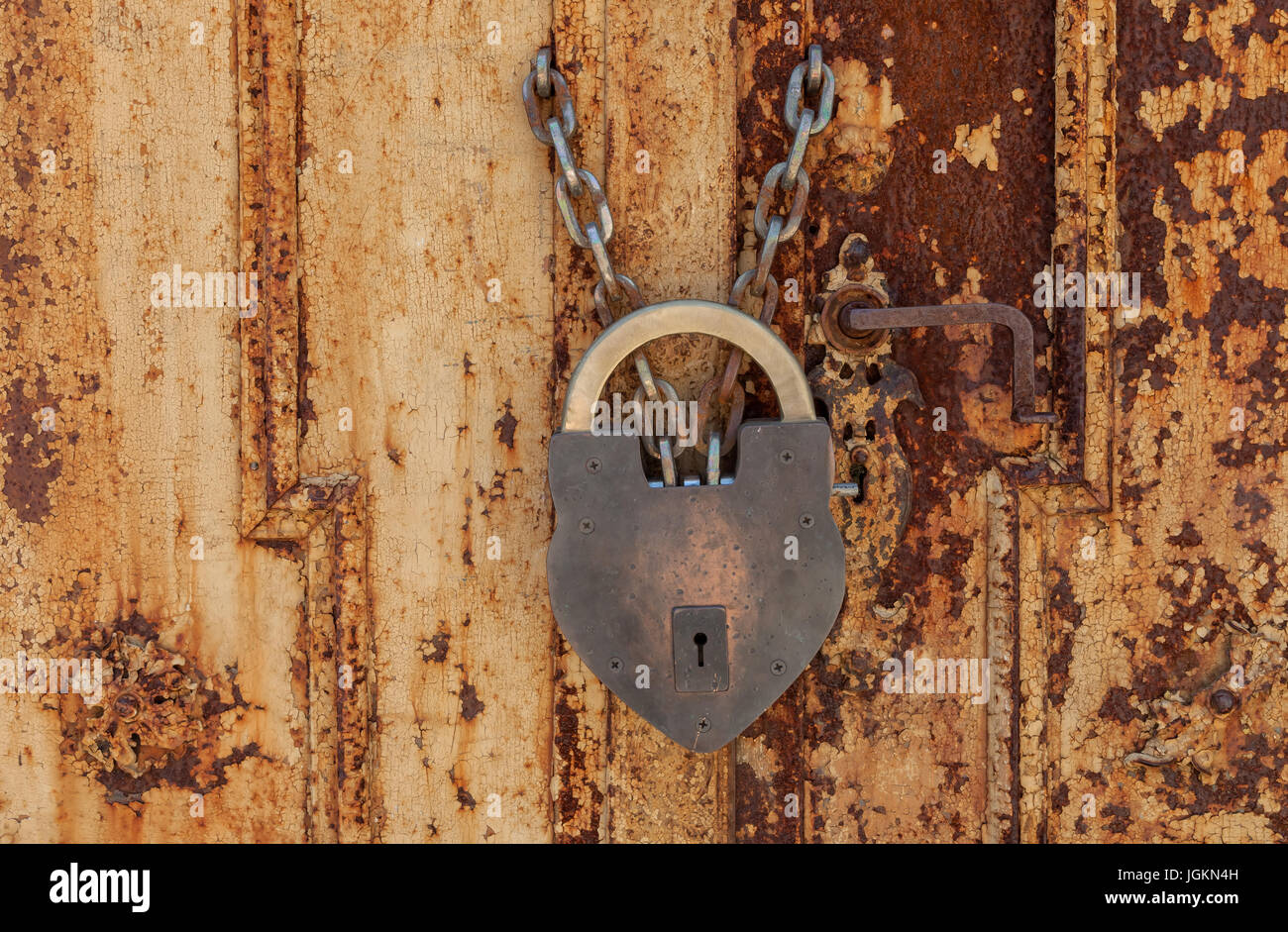 A metal lock on the rusted gate Stock Photo - Alamy