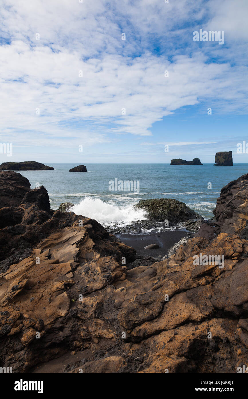 Basalt sea stacks in the ocean off the southern coast of Iceland Stock ...