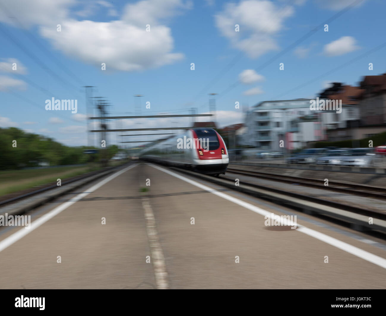 Speeding Train Blurring By in Switzerland Stock Photo - Alamy