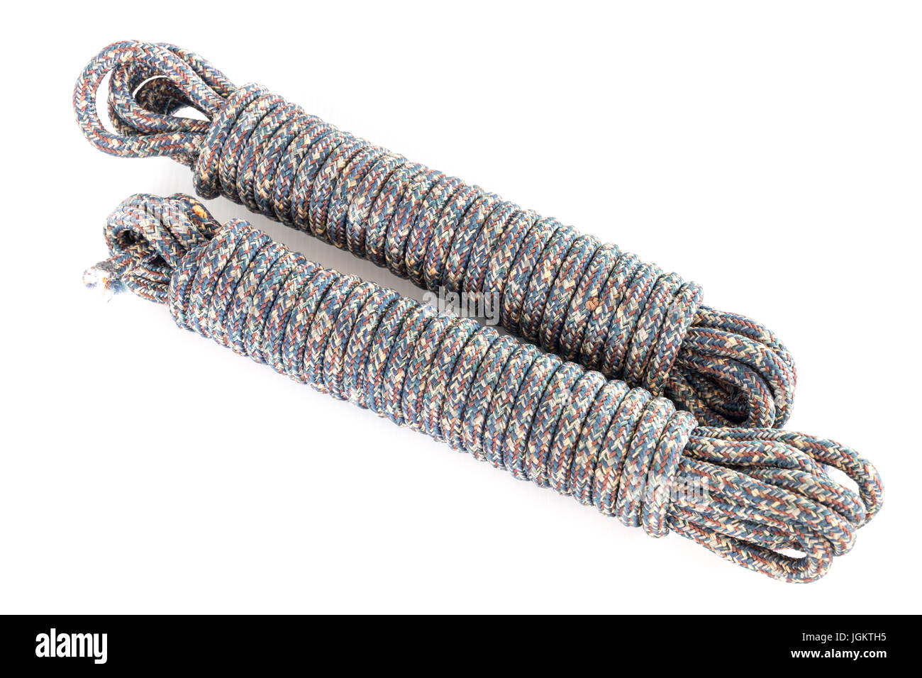 Twisted thick rope on white Stock Photo - Alamy