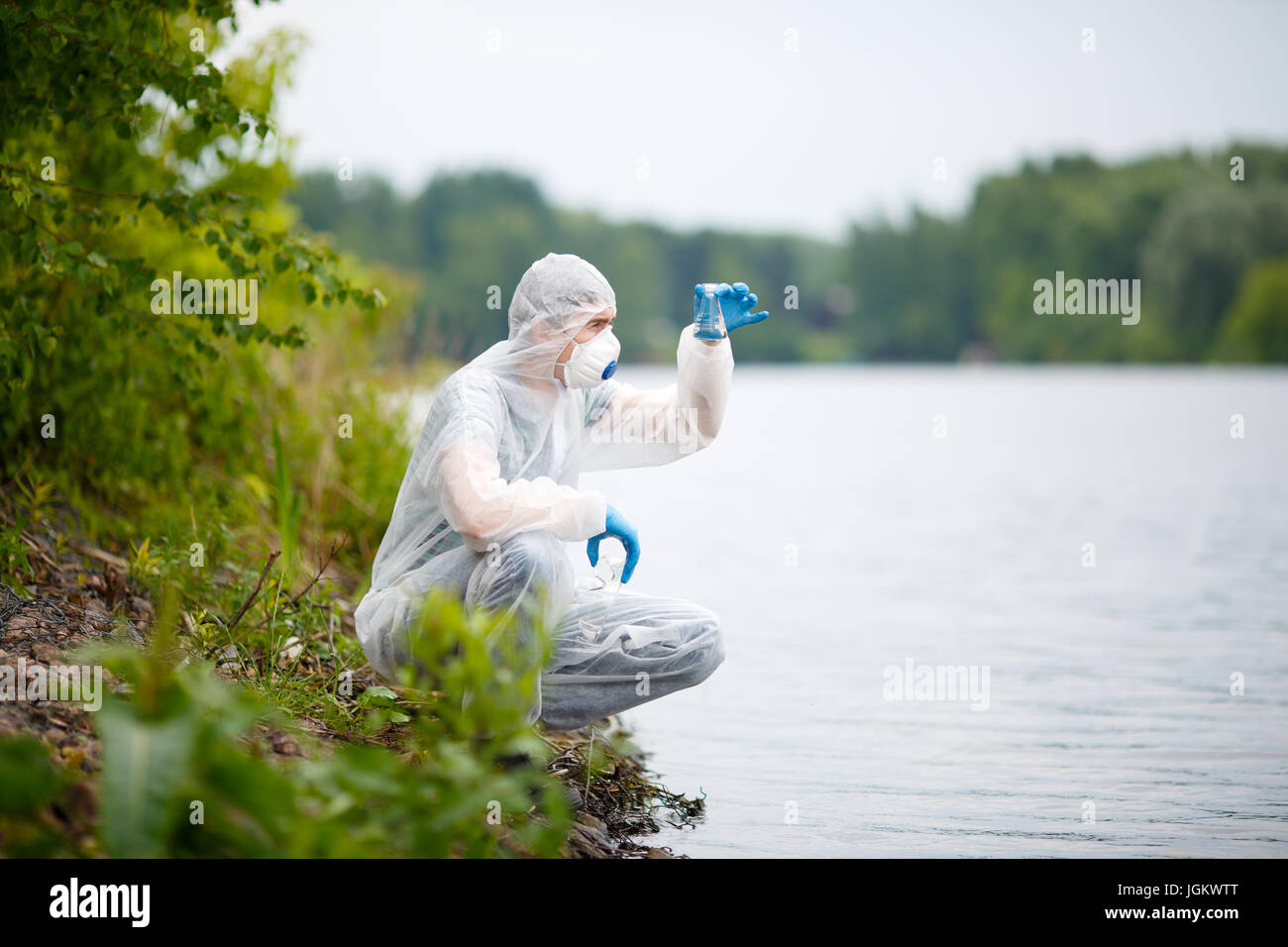 Ecologist with bulb on river Stock Photo - Alamy