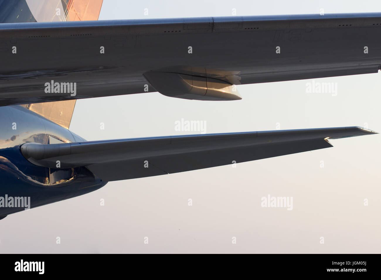 Tail wing of the aircraft in the light of the setting sun, view from ...