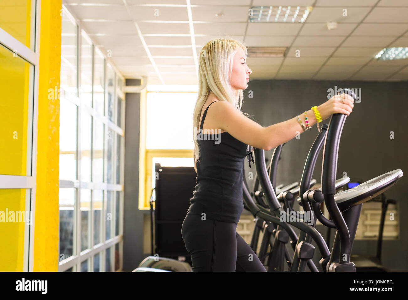 Cardio workout in gym by beautiful female Stock Photo - Alamy