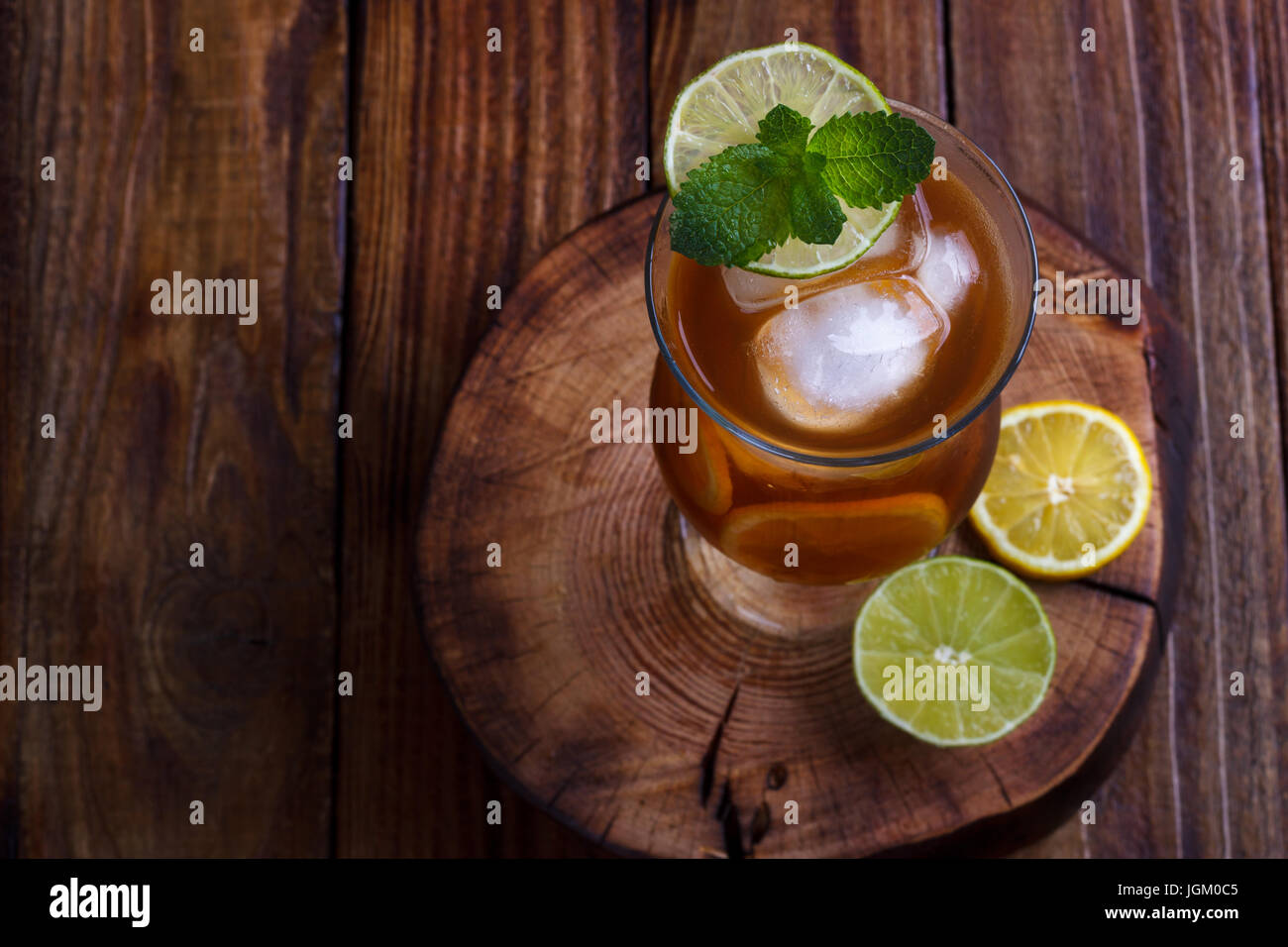 Iced tea with lemon, lime slices and mint on rustic background Stock ...
