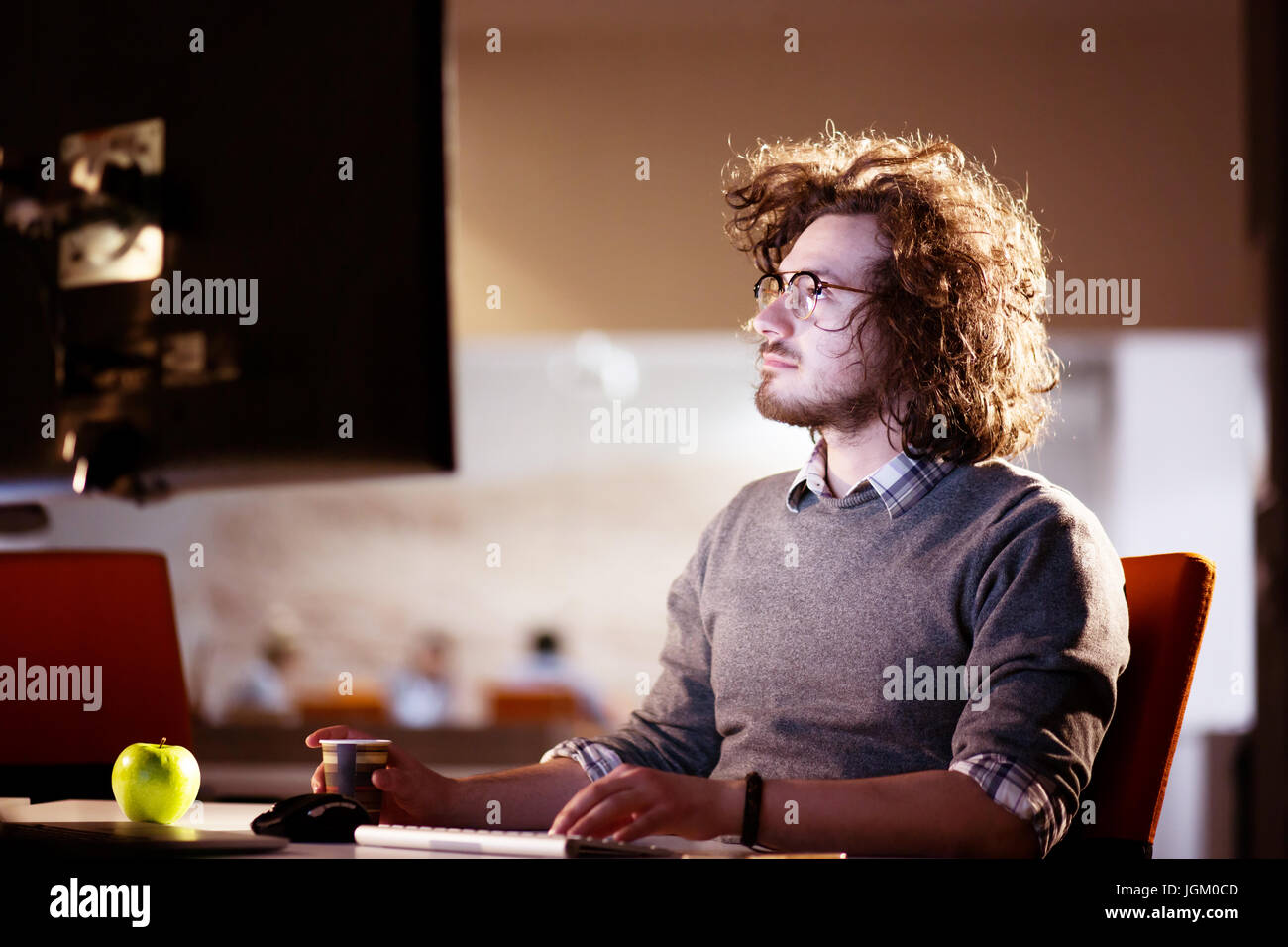 Tired businessman working late doing overtime in office at night ...