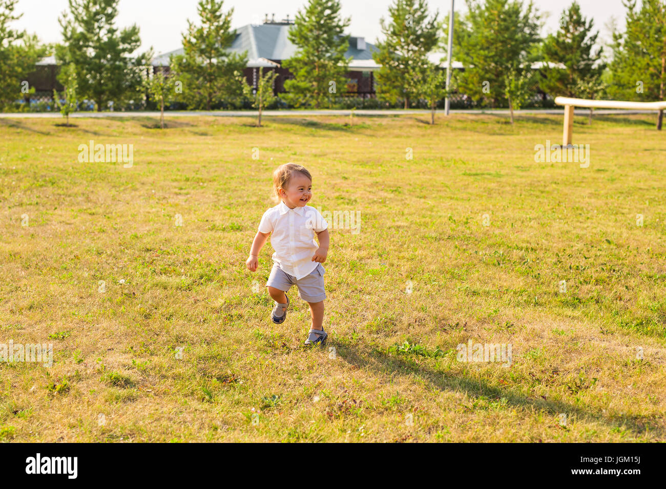 Happy baby boy running on summer field Stock Photo - Alamy