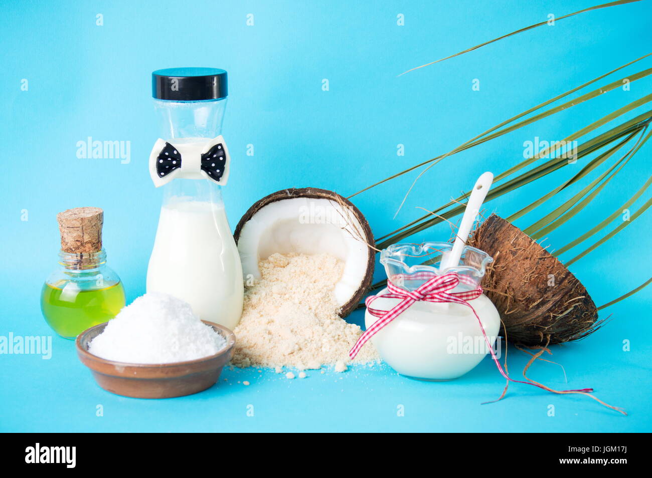 Various coconut products collection against blue background Stock Photo ...