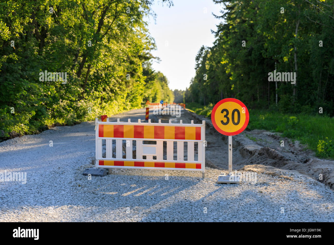 Road block and a speed limit sign on a road under construction Stock ...