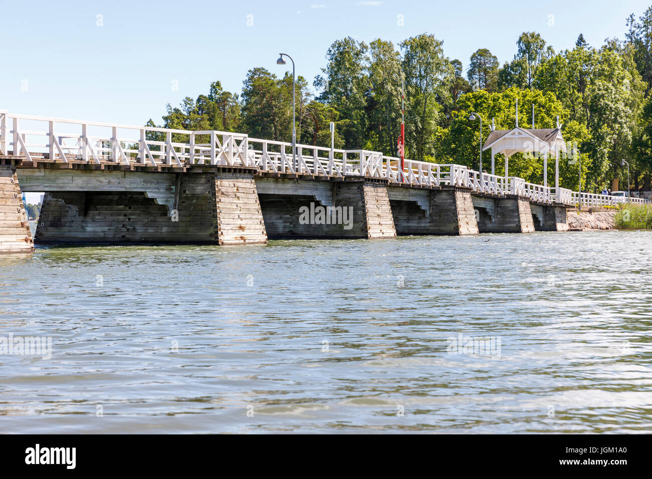 White pedestrian bridge over water between an island and land Stock ...