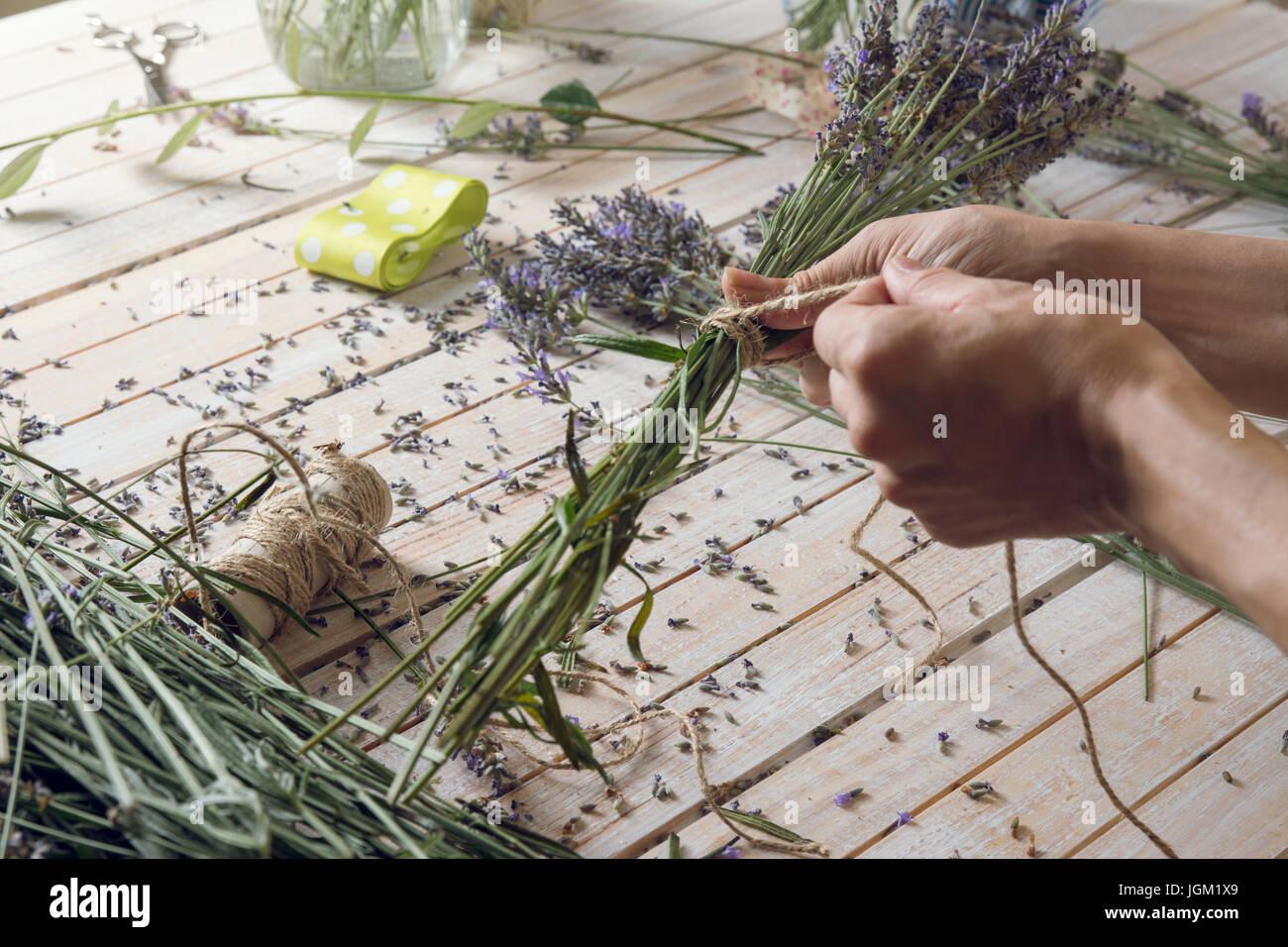Florist at work: woman creating bouquet of natural lavender flowers ...