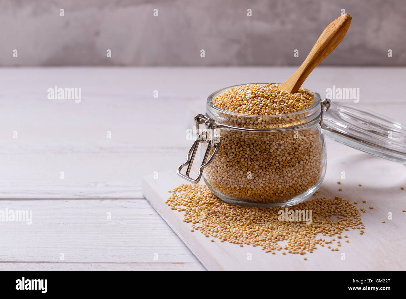 White quinoa seeds in a jar on white wooden table, closeup Stock Photo ...
