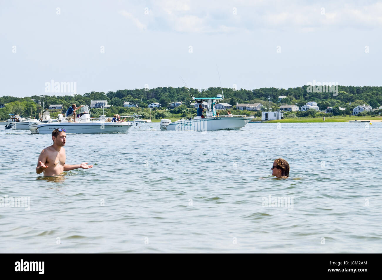 Wellfleet, USA - July 30, 2014: People swimming in ocean at Cape Cod ...