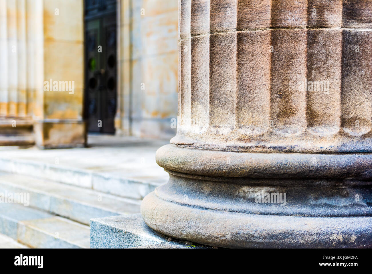 Closeup of old vintage columns of European style building wet from rain ...