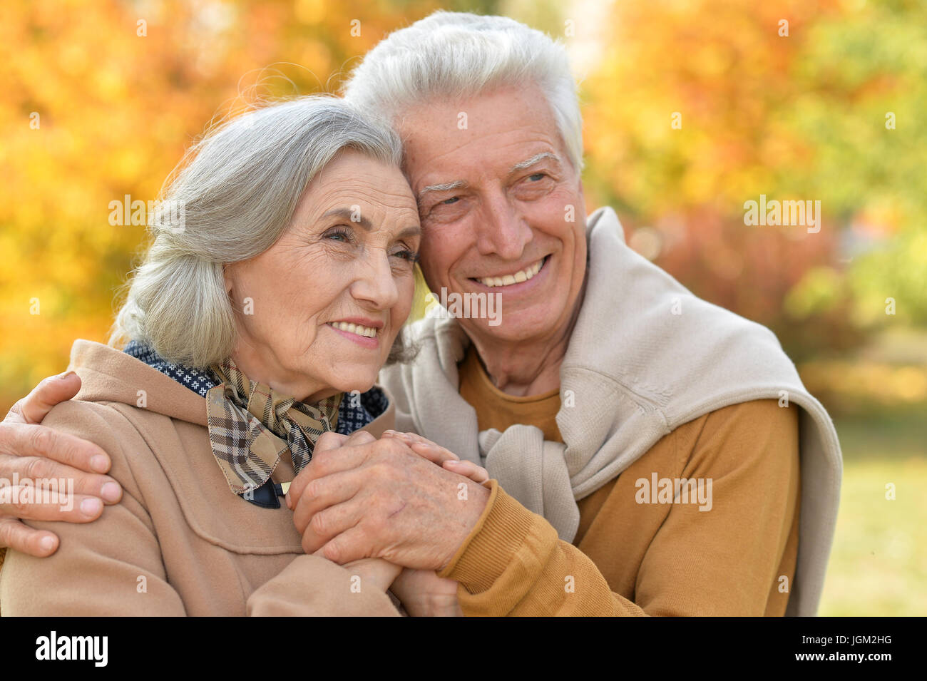 senior couple hugging in the park Stock Photo - Alamy