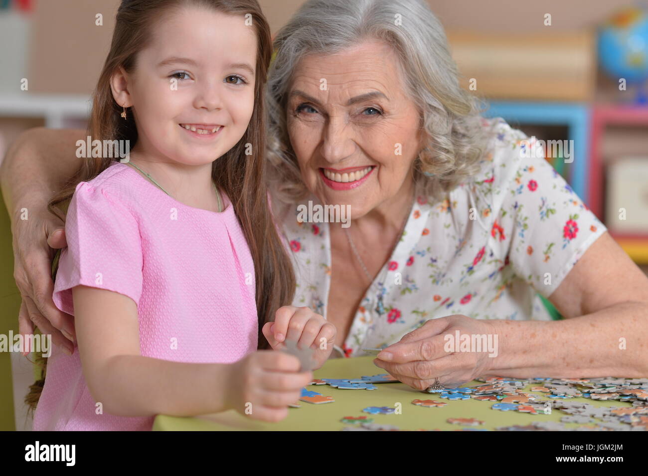 Grandmother collecting puzzle Stock Photo - Alamy