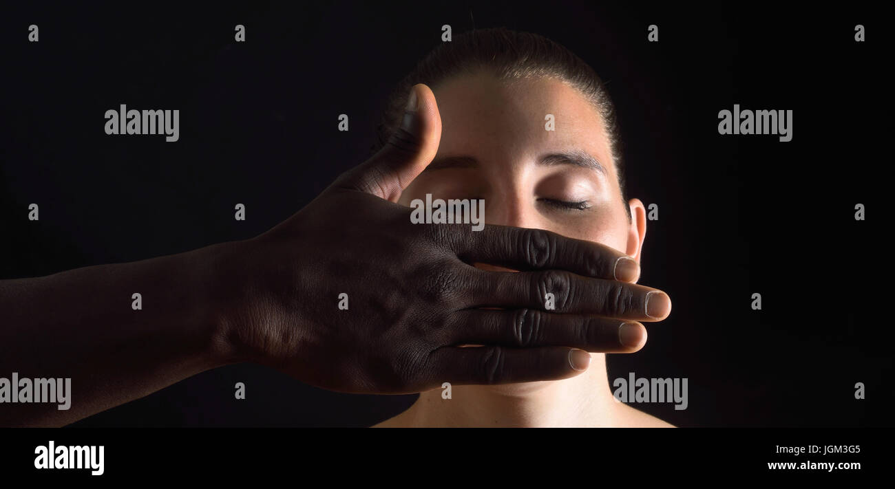 a hand covering mouth of caucasian woman on black Stock Photo - Alamy